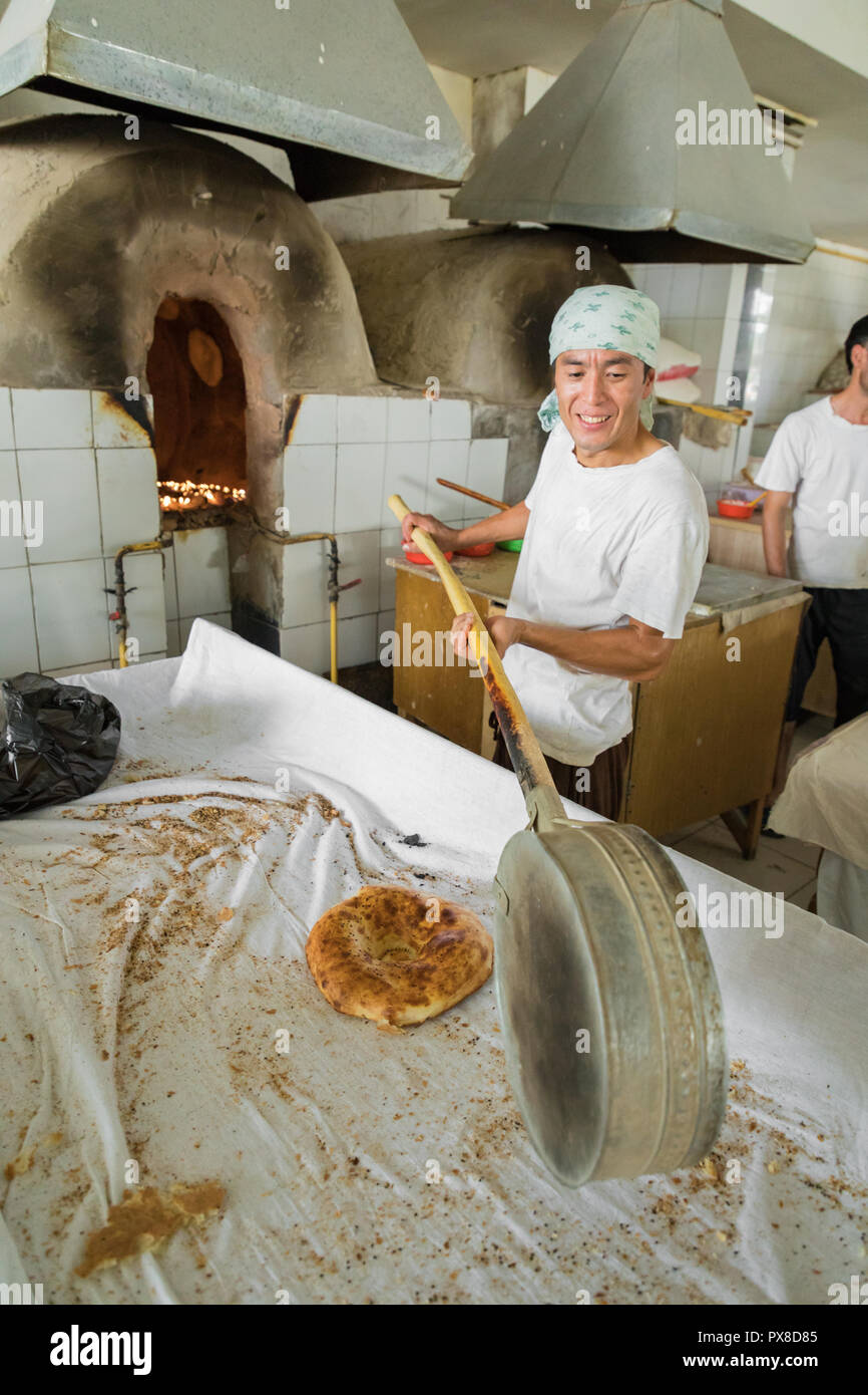 TASHKENT, UZBEKISTAN - AUGUST 22, 2018: Uzbek people baking traditional ...