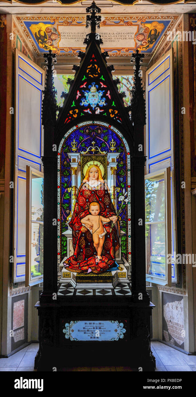Stained glass image of Virgin and child Jesus backlit against window of ...