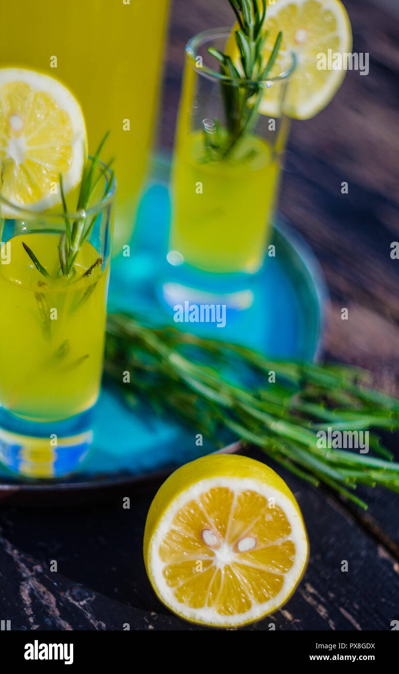 Traditional italian lemon alcohol drink limoncello with pieces of lemon ...