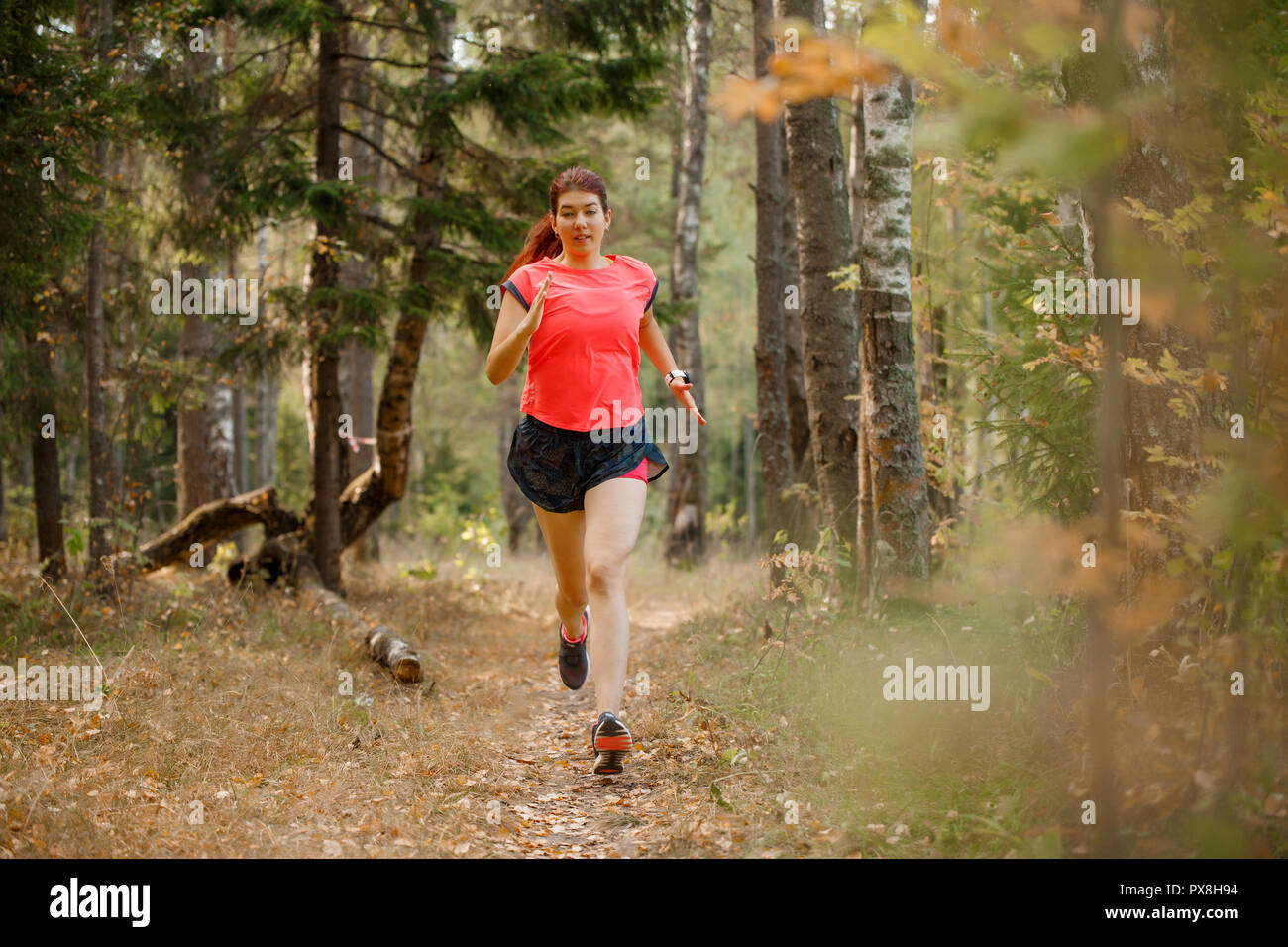 Photo of sports woman running through park Stock Photo - Alamy