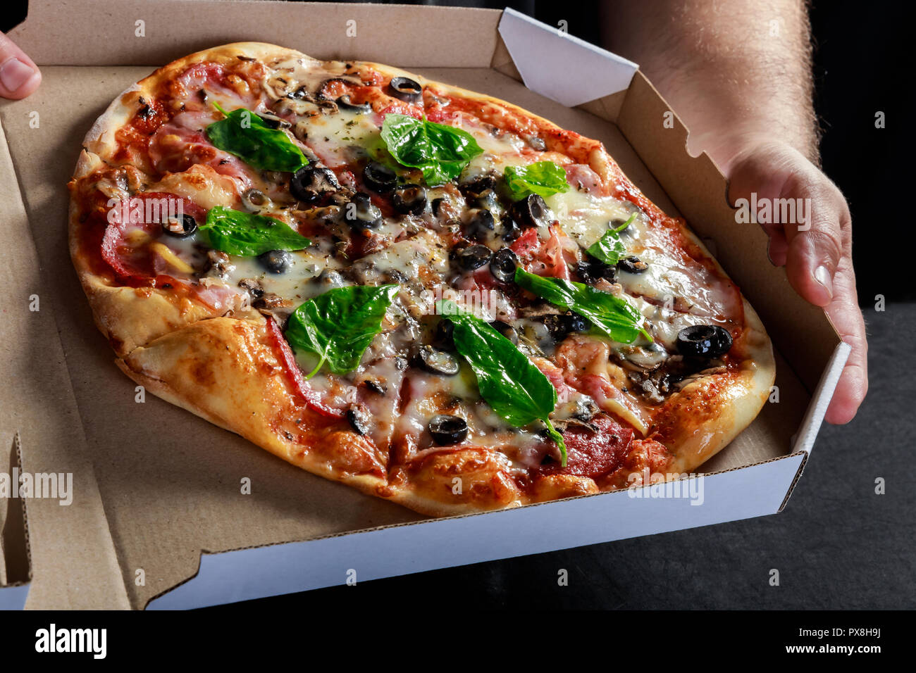 Pizza box delivery concept. Open box with hot tasty italian sliced ...