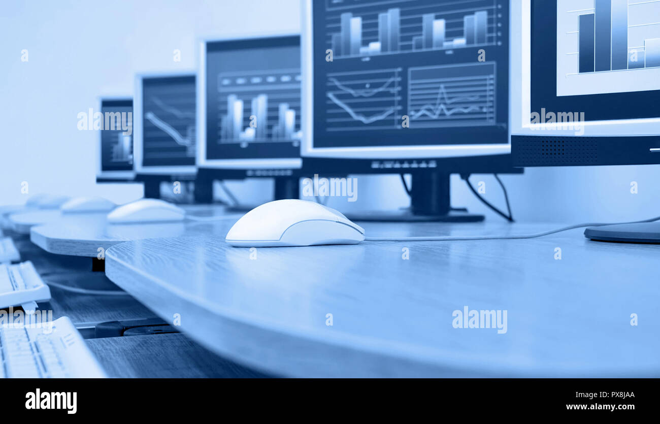Row of computer monitors in classroom. Picture in blue tint Stock Photo ...