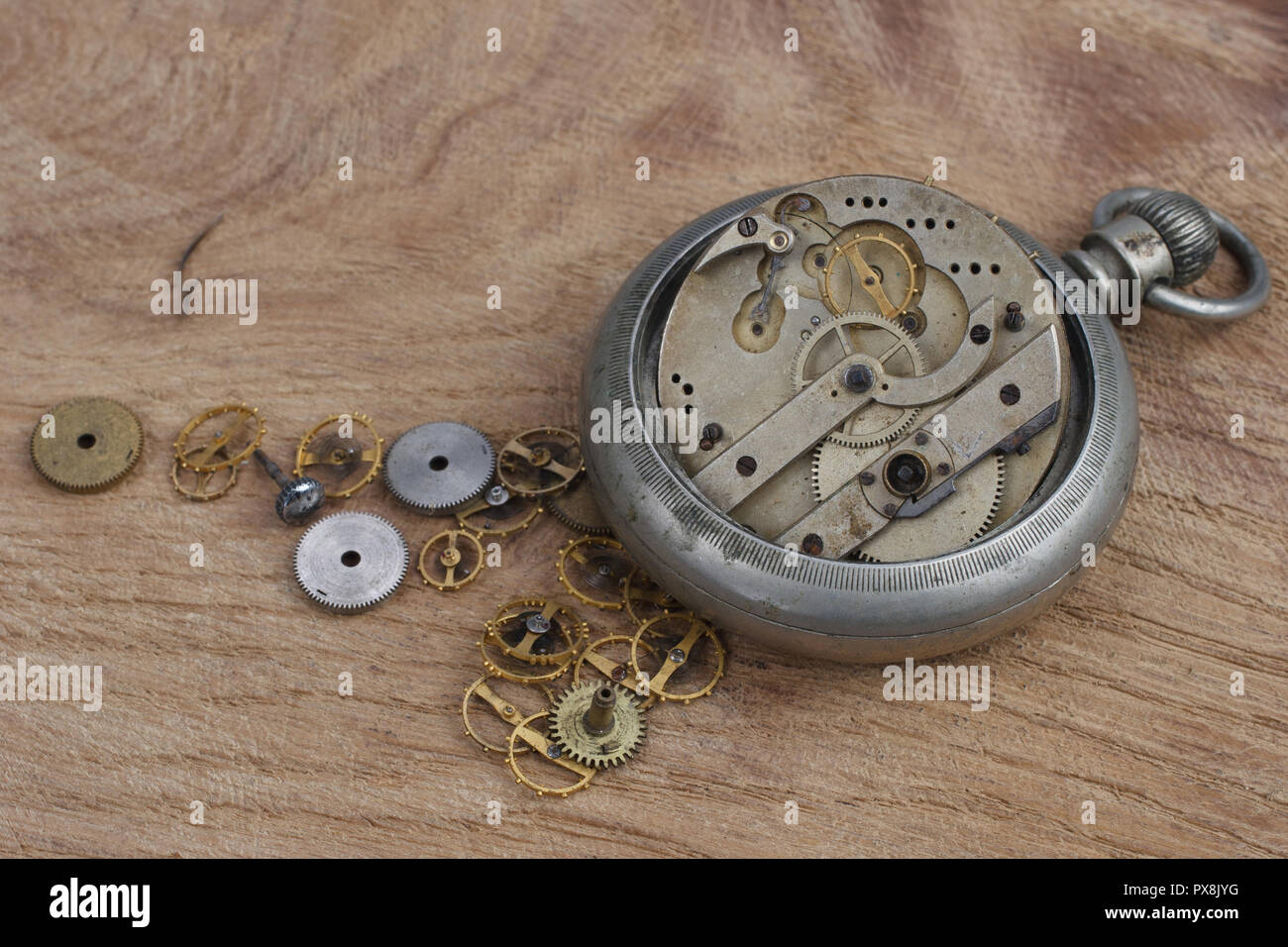 Time concept - broken vintage pocket watch on wooden desk Stock Photo ...