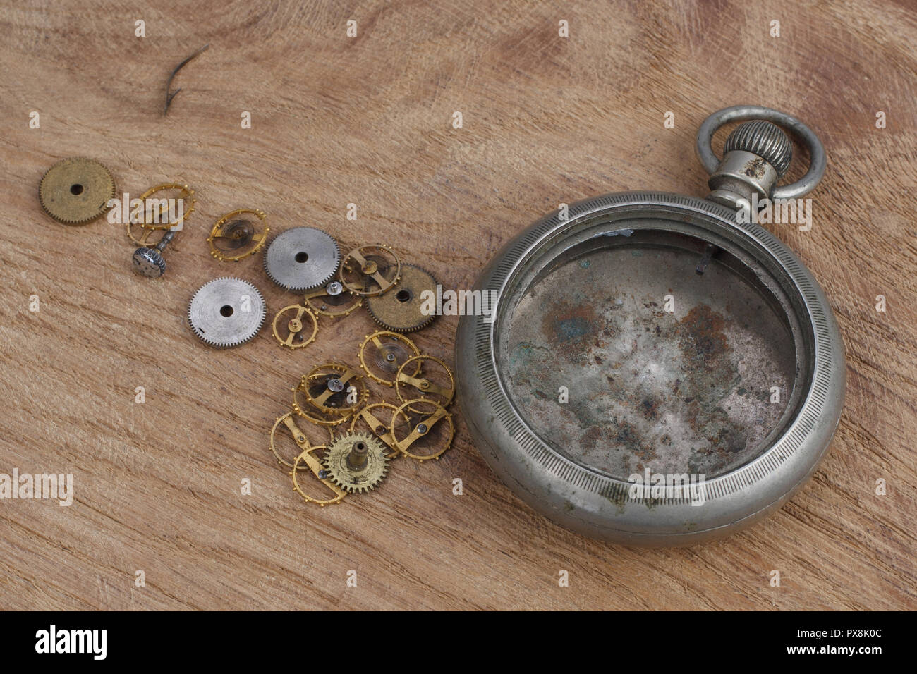 Time concept - broken vintage pocket watch on wooden desk Stock Photo ...
