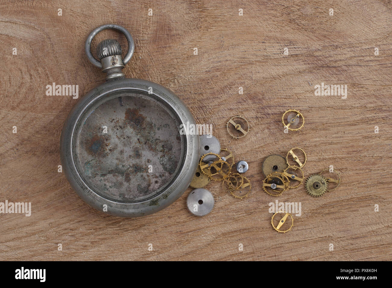 Time concept - broken vintage pocket watch on wooden desk Stock Photo ...