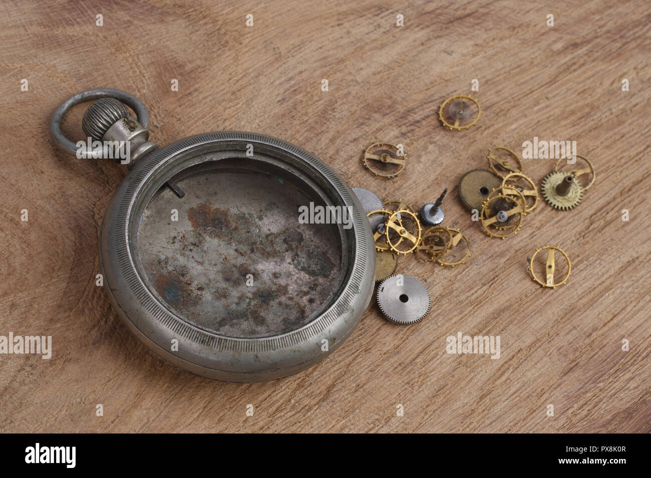 Time concept - broken vintage pocket watch on wooden desk Stock Photo ...