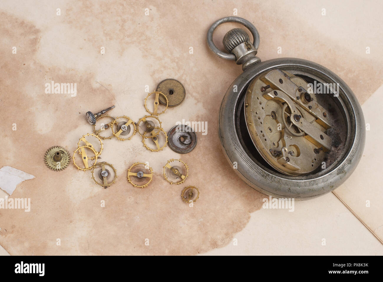 Time concept - broken vintage pocket watch on dirty paper background on ...