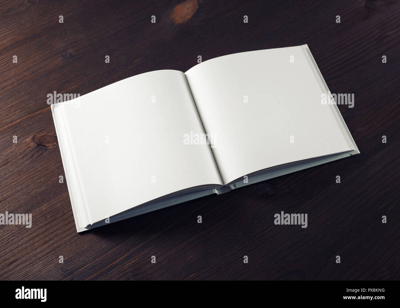 Mockup of open book on wood table background. Responsive design ...