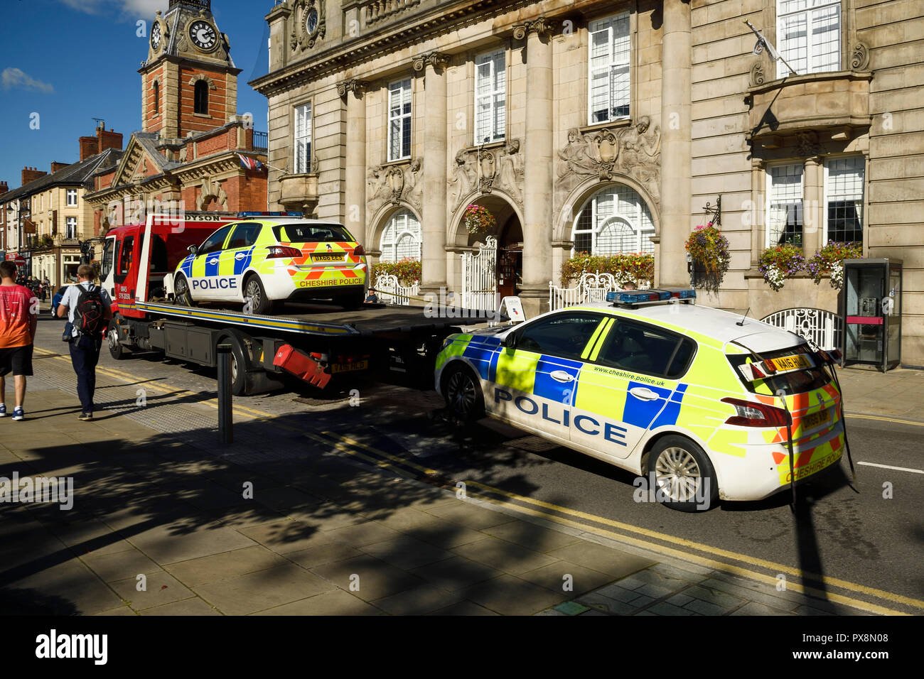 Two police cars being transported on a recovery vehicle through Crewe ...