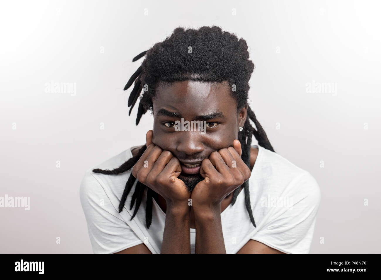 Scared man face with dreadlocks on white background Stock Photo - Alamy
