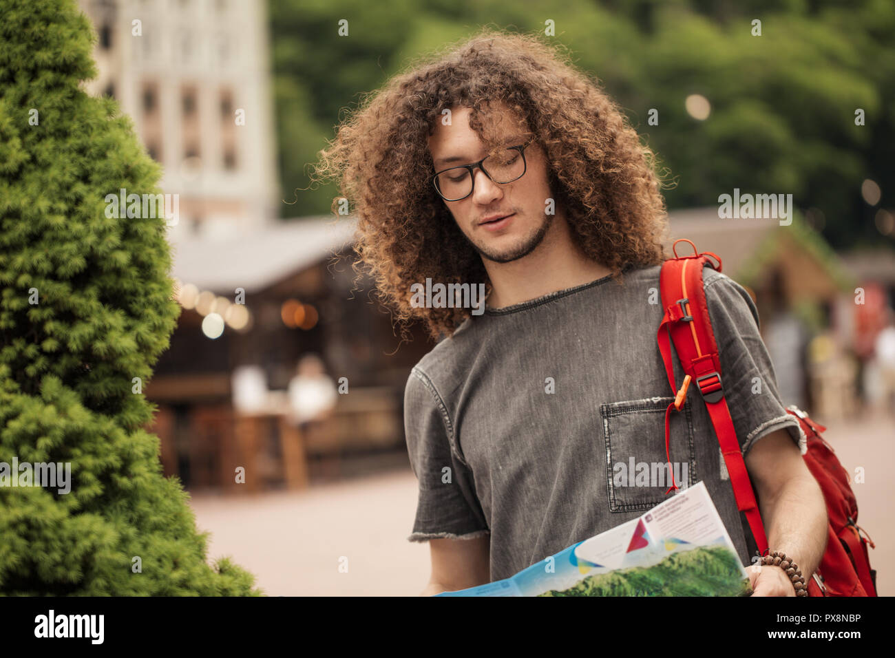 tourist with route maps looking for a way in city. search landmarks ...