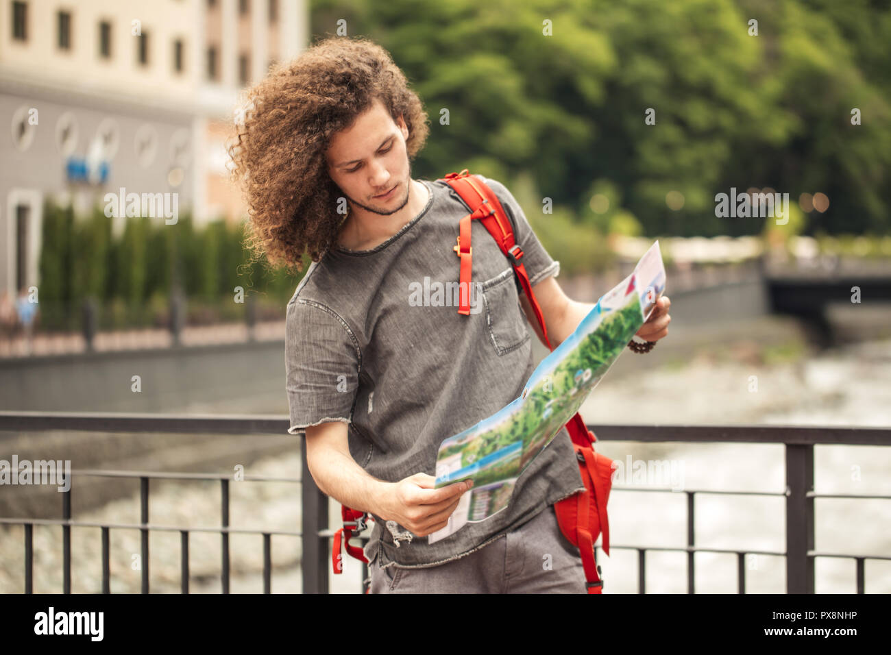 tourist with route maps looking for a way in city. search landmarks ...