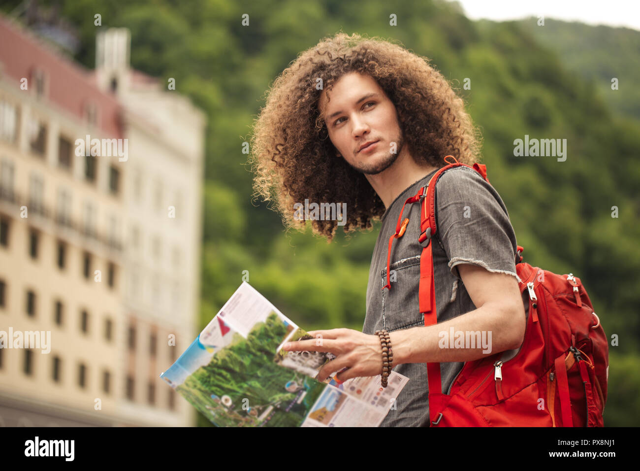 tourist with route maps looking for a way in city. search landmarks ...