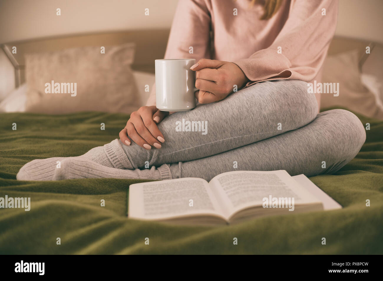 Photo of woman relaxing while reading a book and drinking coffee Stock ...
