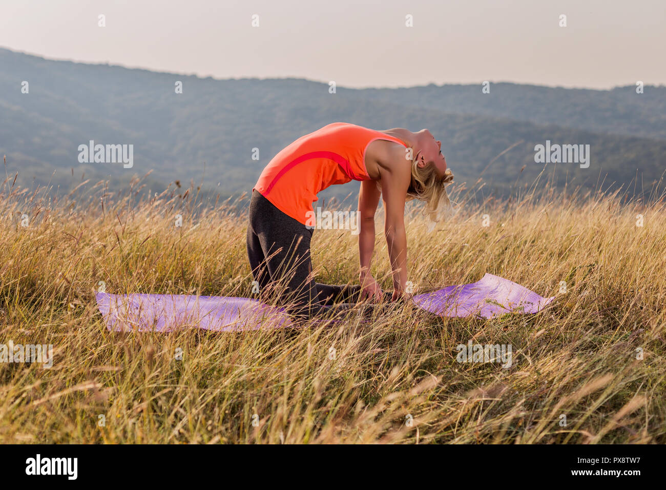 Beautiful woman doing yoga in the nature,Ustrasana advanced/Camel pose ...
