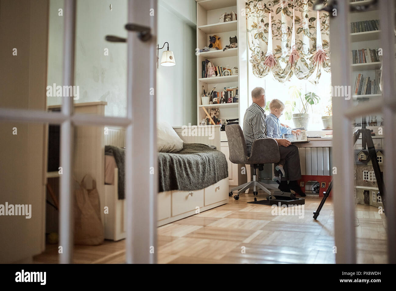 Grandfather and grandson on sofa at home. Grandpa and children watching ...