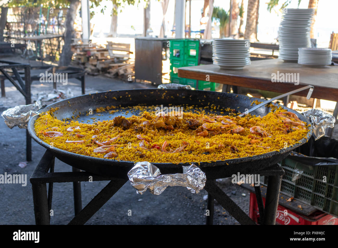 Paella cooked in an outdoor restaurant in Spain; beach side dining ...