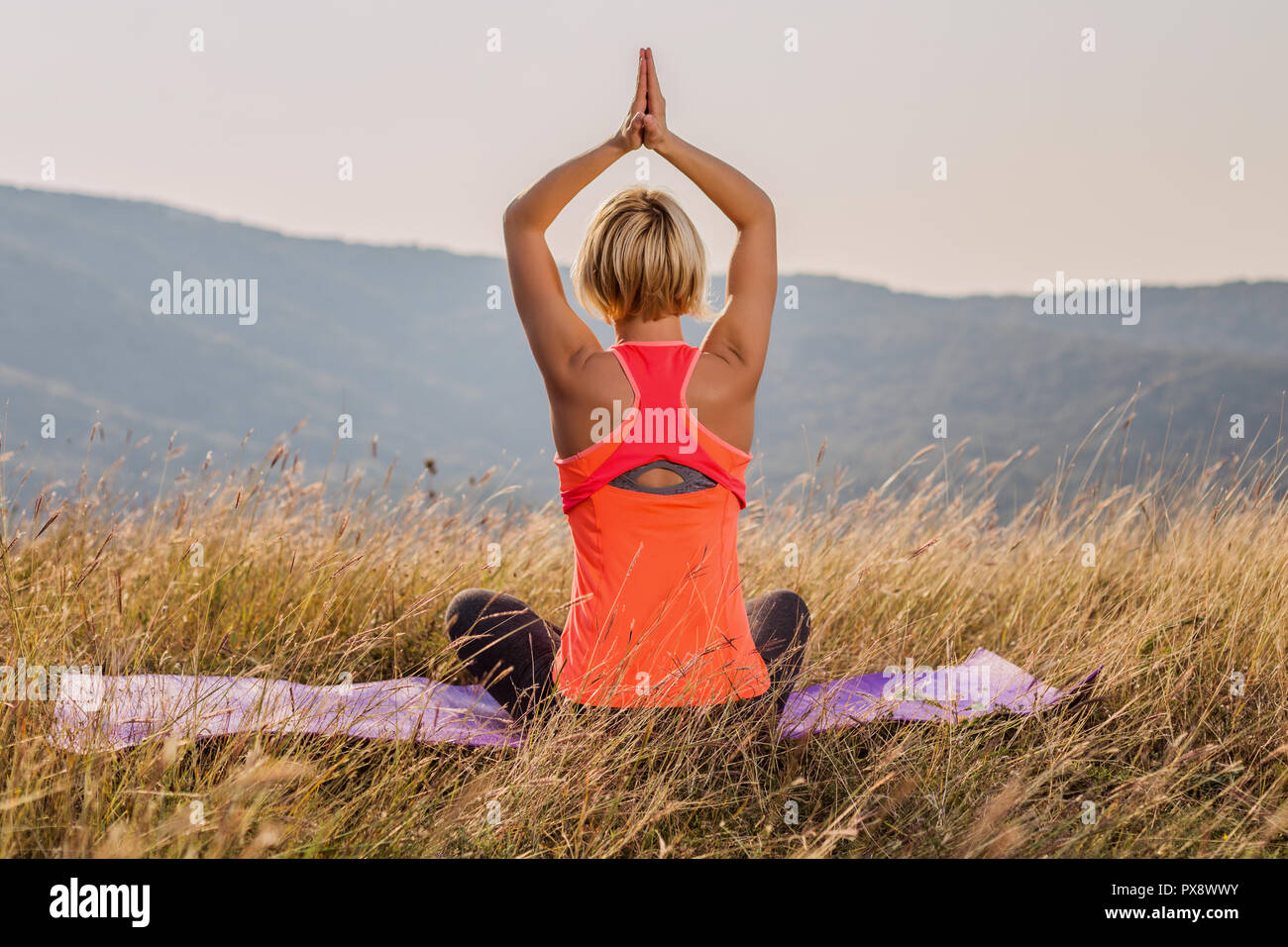 Woman sittting in lotus position and meditating in the nature,Padmasana ...