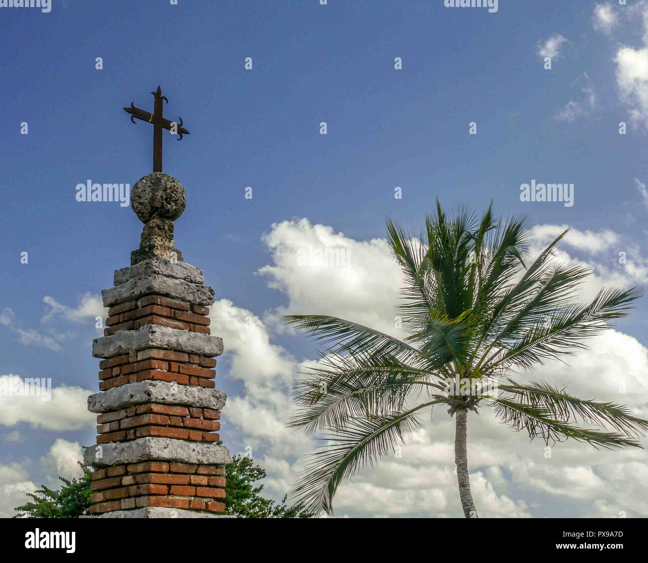 La Romana, Dominican Republic. 14th Jan, 2009. A palm tree and a cross ...
