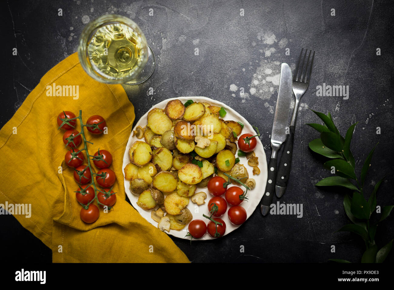 Table setting for holiday dinner. Fried potatoes with mushrooms and ...