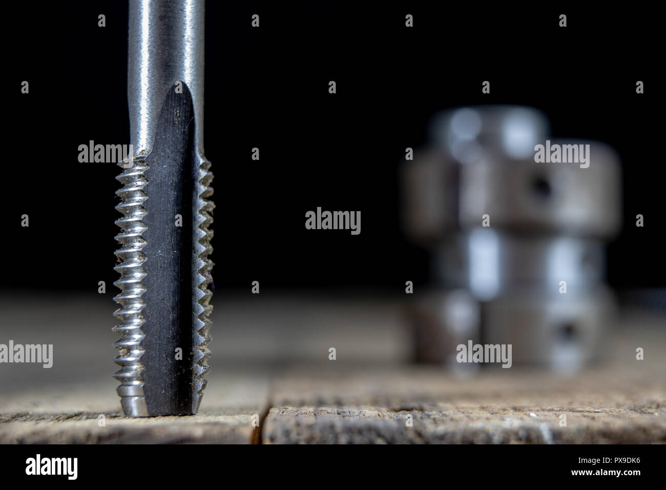 Metalwork tools on the workshop table. Threading dies and taps in an ...