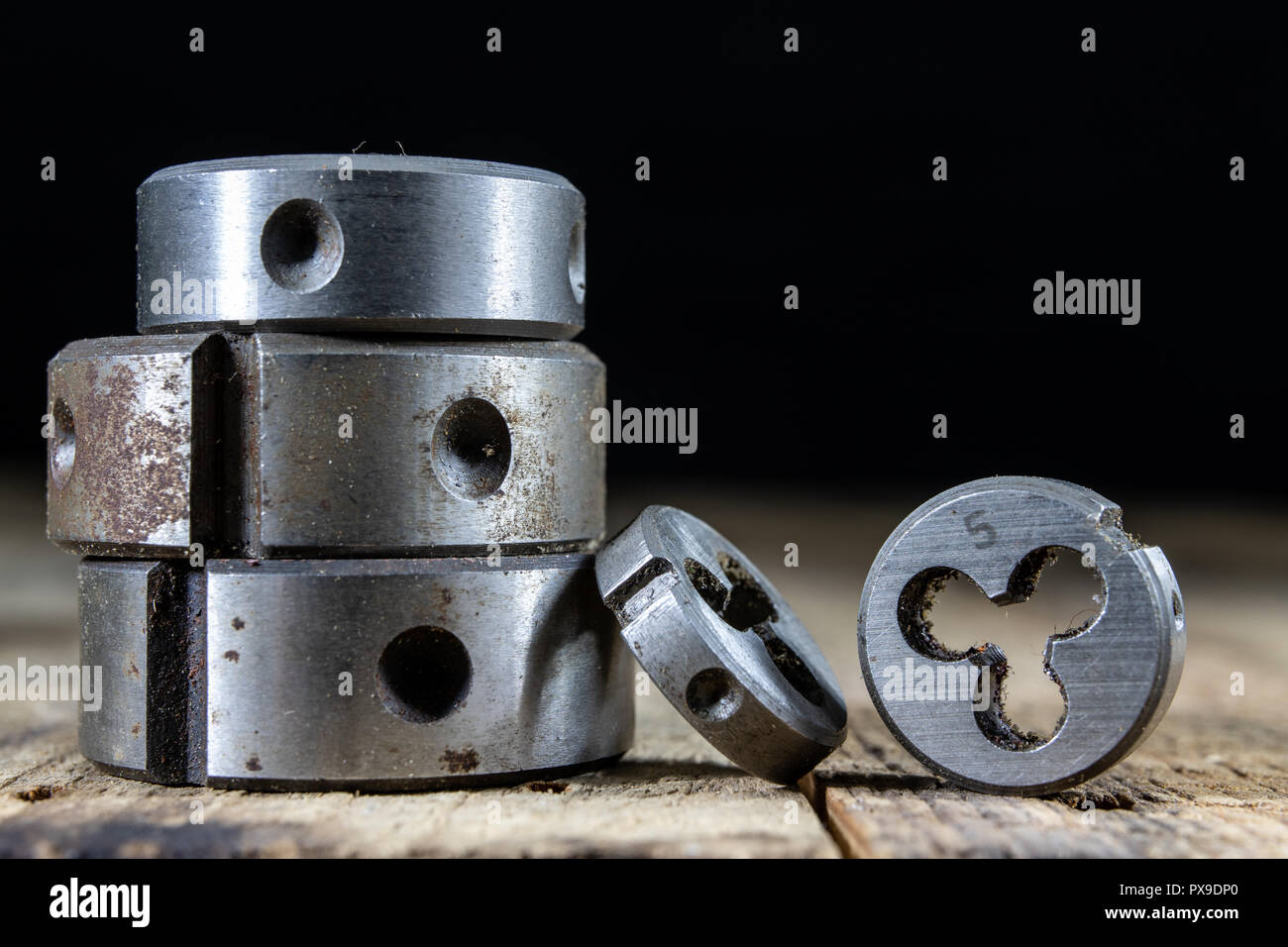 Metalwork tools on the workshop table. Threading dies and taps in an ...