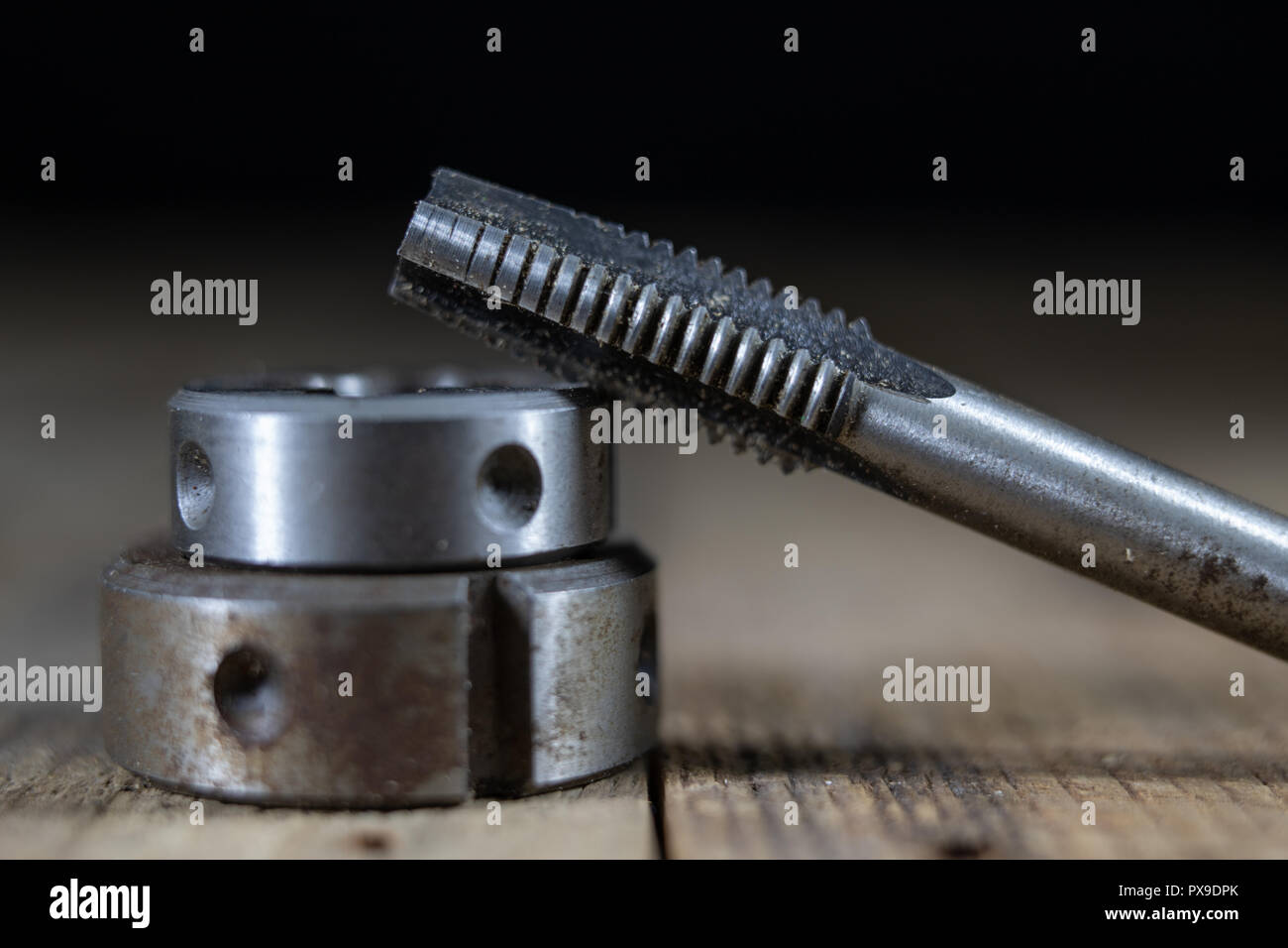 Metalwork tools on the workshop table. Threading dies and taps in an ...