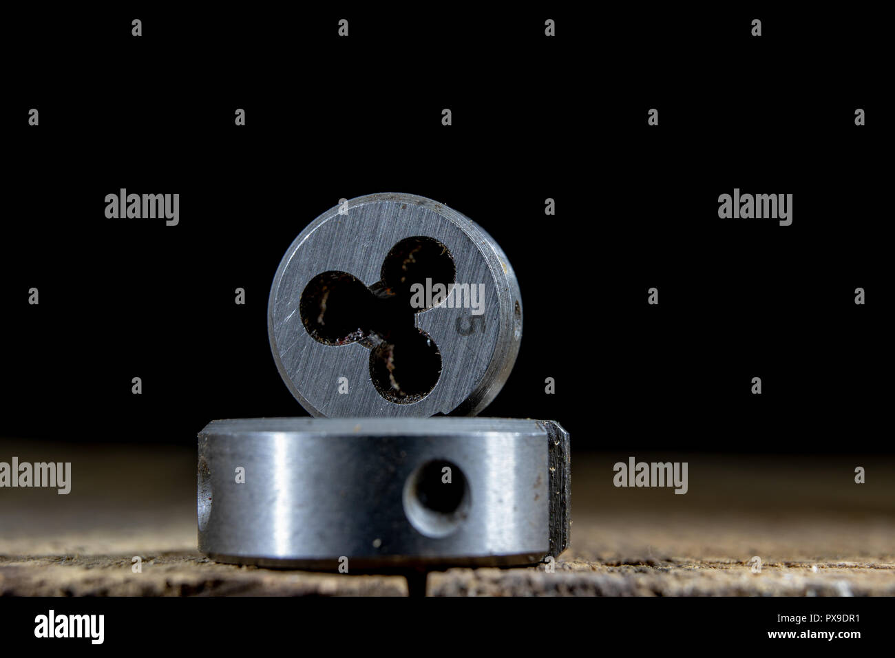 Metalwork tools on the workshop table. Threading dies and taps in an ...