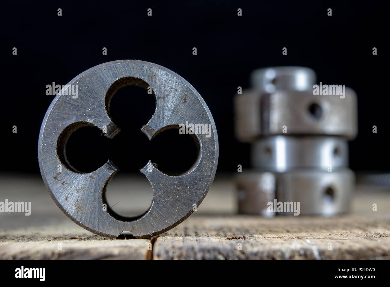 Metalwork tools on the workshop table. Threading dies and taps in an ...