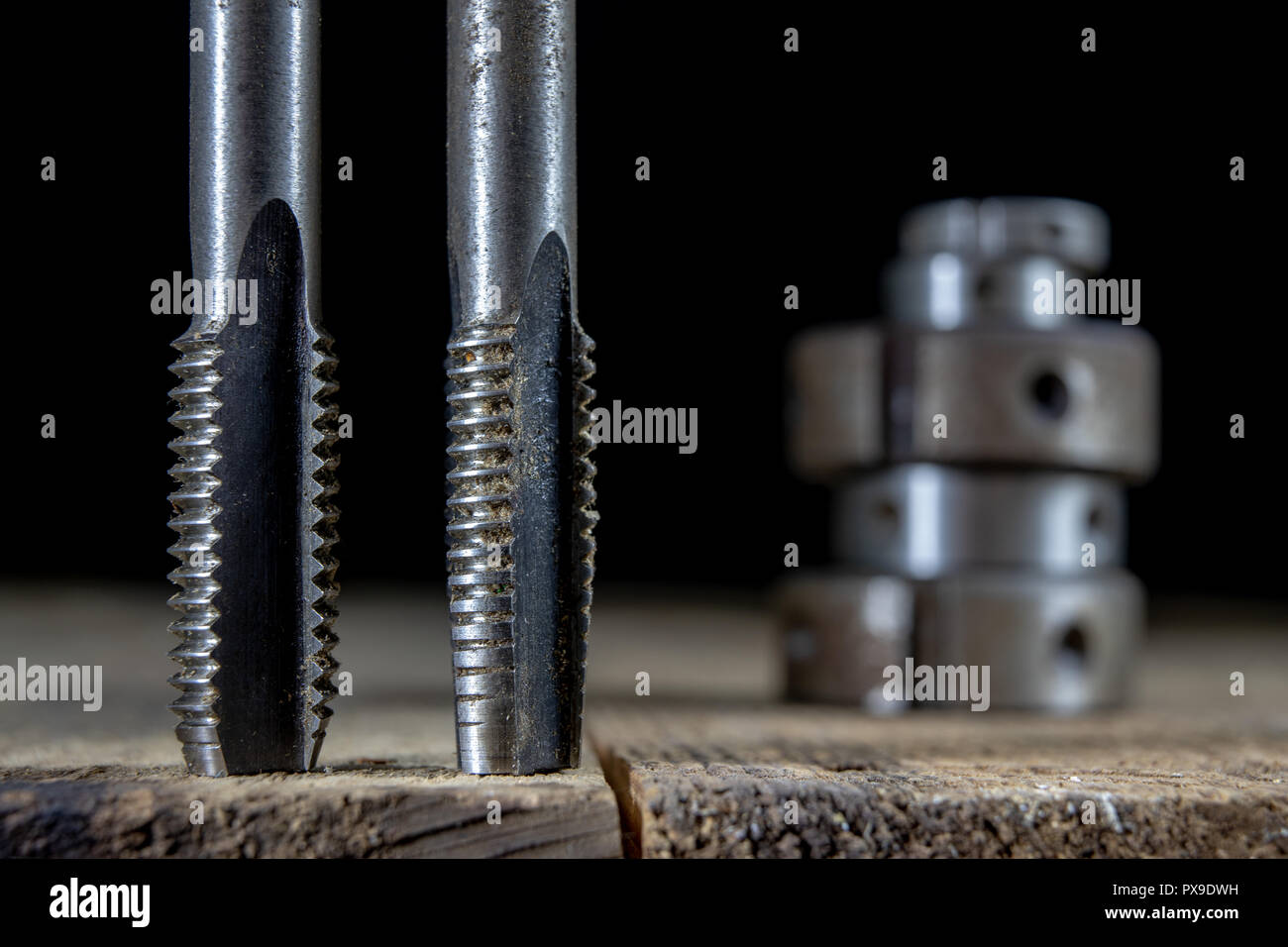 Metalwork tools on the workshop table. Threading dies and taps in an ...