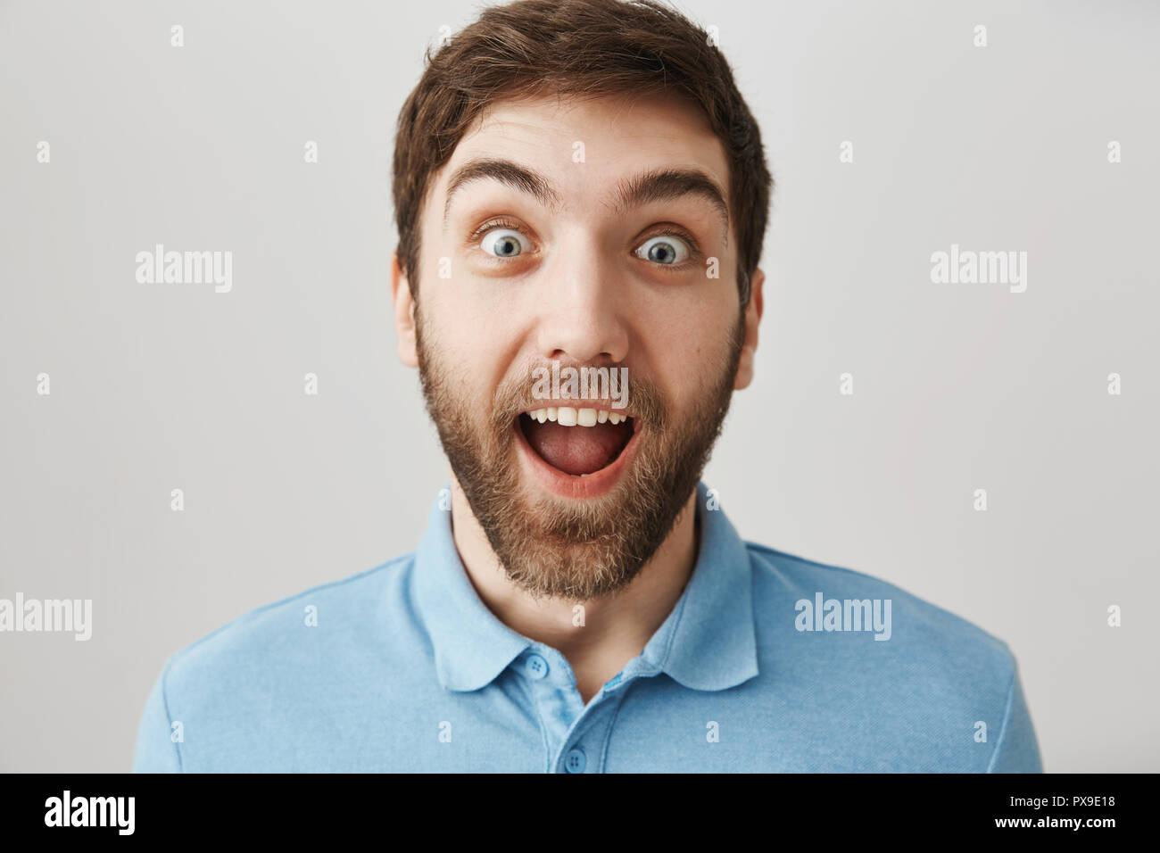 Happiest man on earth. Studio shot of excited and surprised caucasian ...