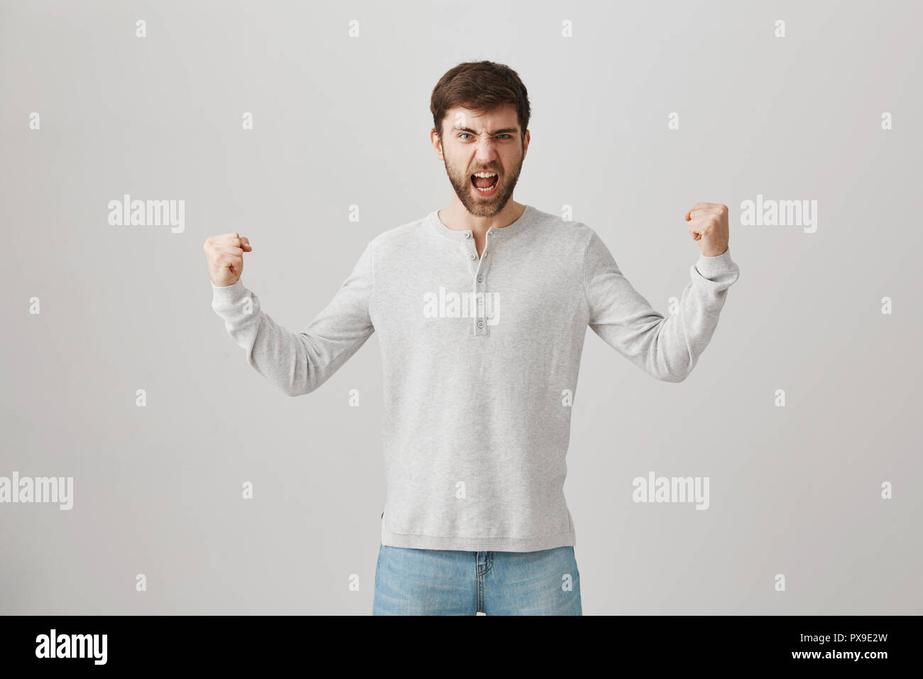 Man proves he is strong and powerful. Portrait of handsome bearded guy ...