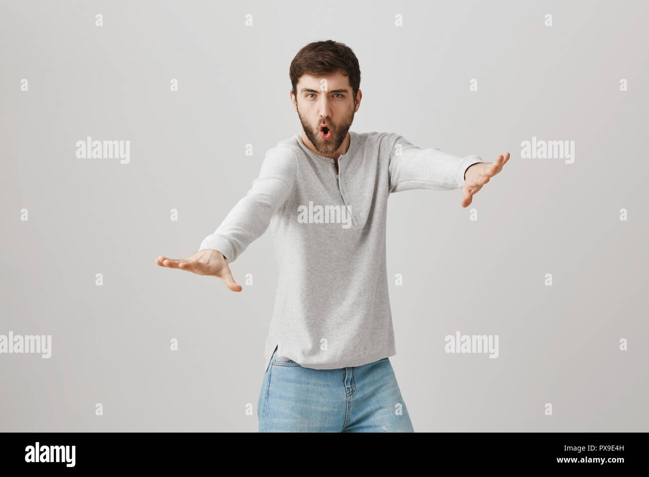 Stay where you are, no one move. Studio shot of active funny male with ...