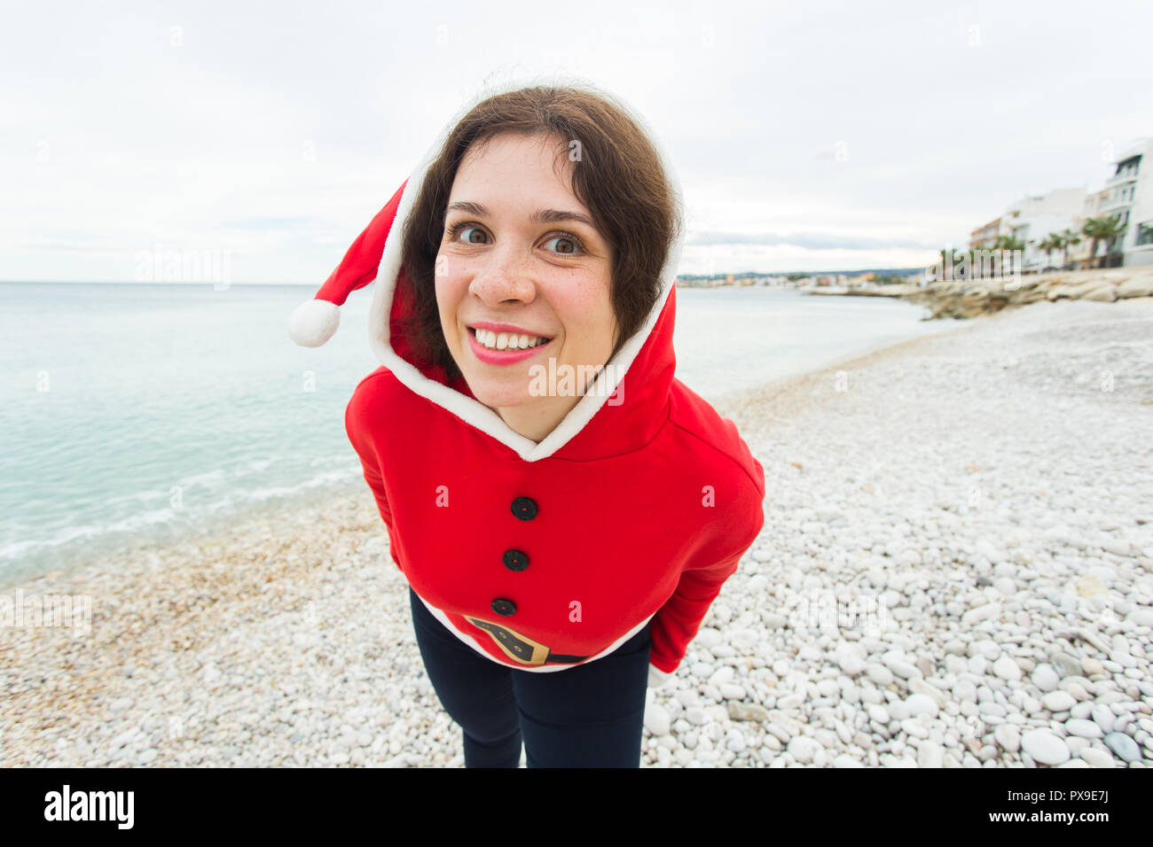 Christmas and holiday concept - Funny woman in Santa Claus costume ...