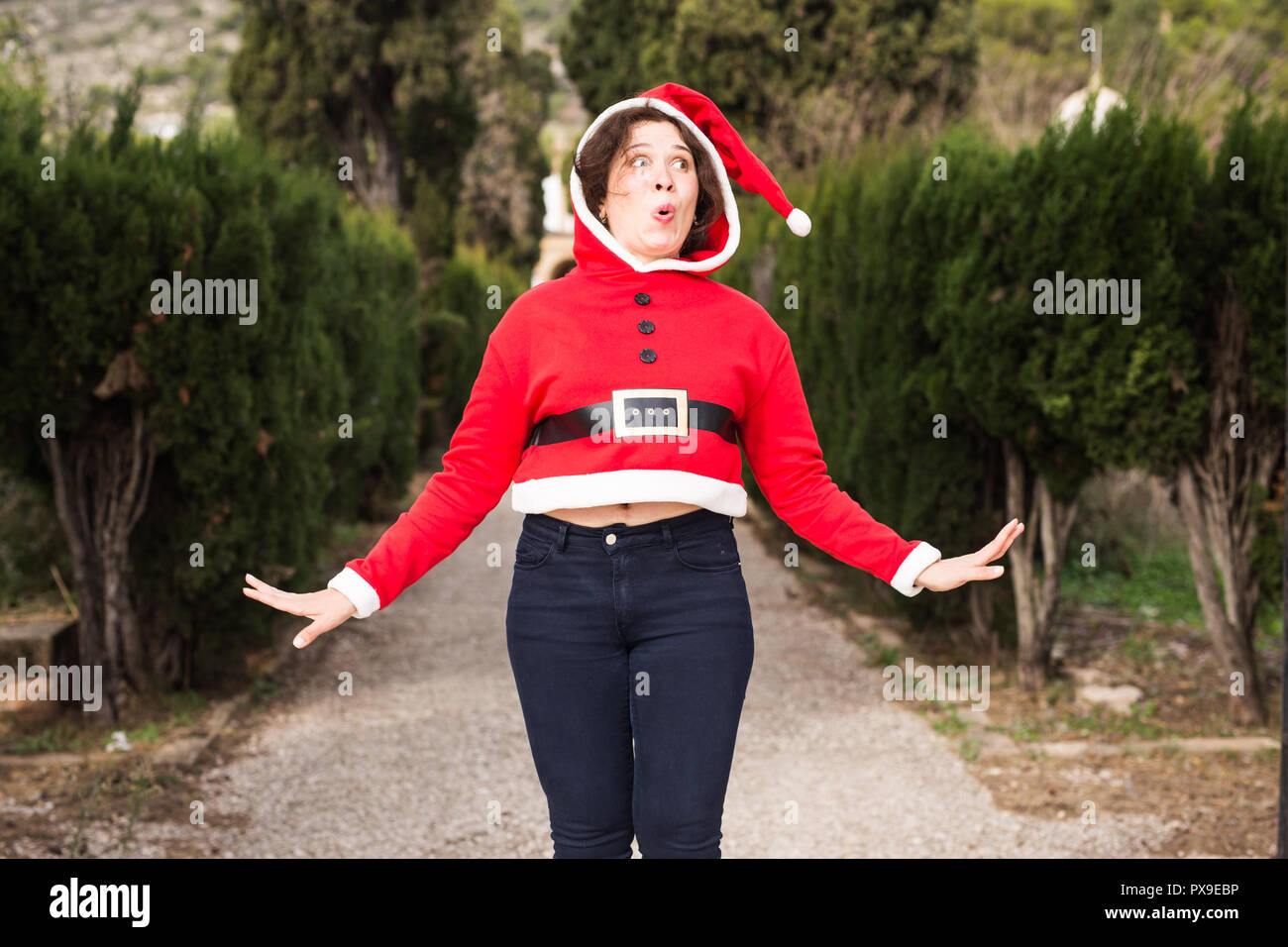 Christmas and holiday concept - Happy woman having fan in Santa Claus ...