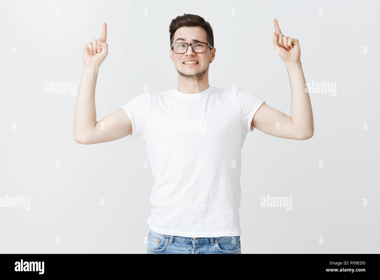 Ouch that hurts. Intense worried and awkward young male model in ...