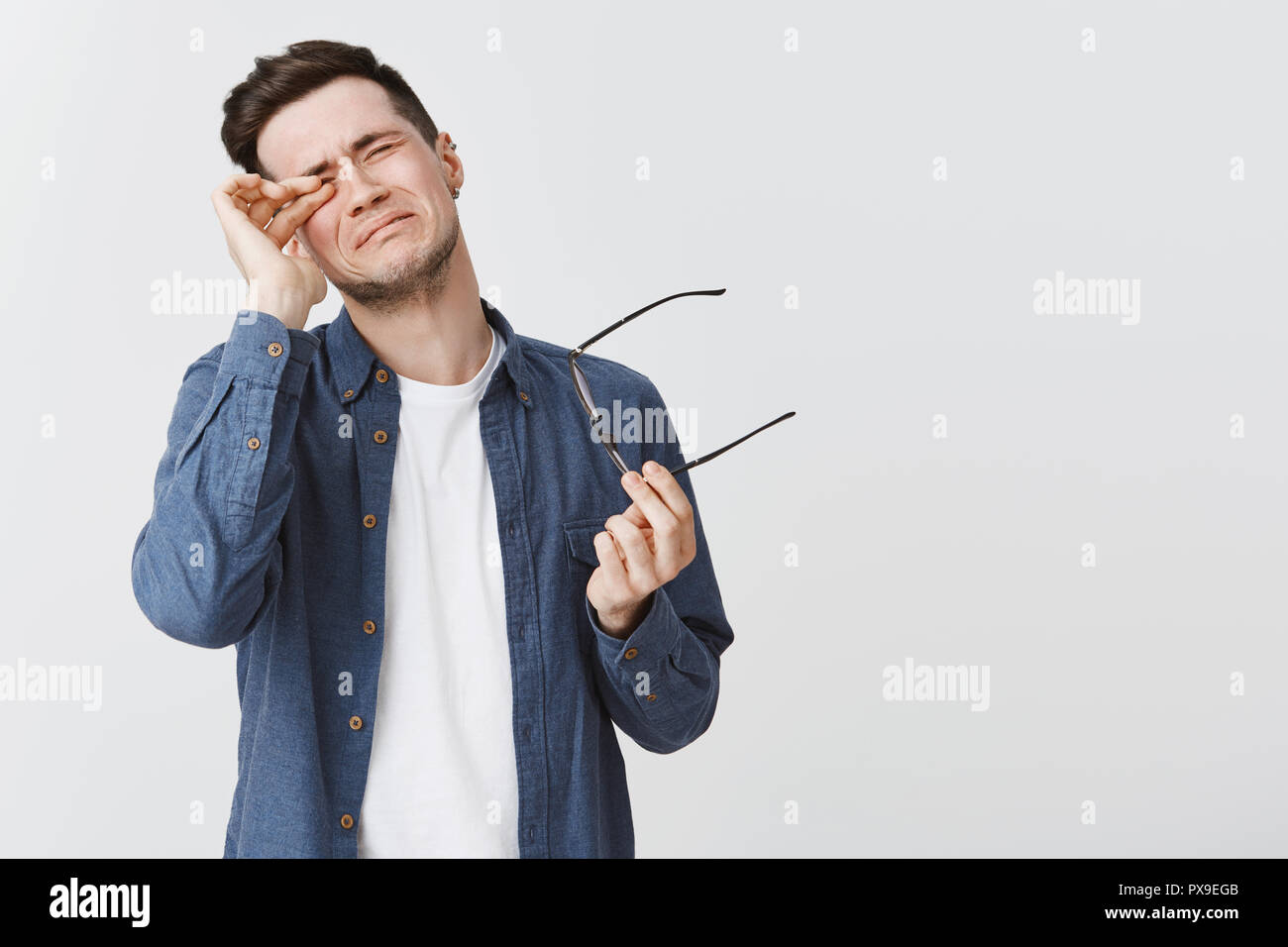 Portrait of sad and miserable suffering male digital nomad crying ...