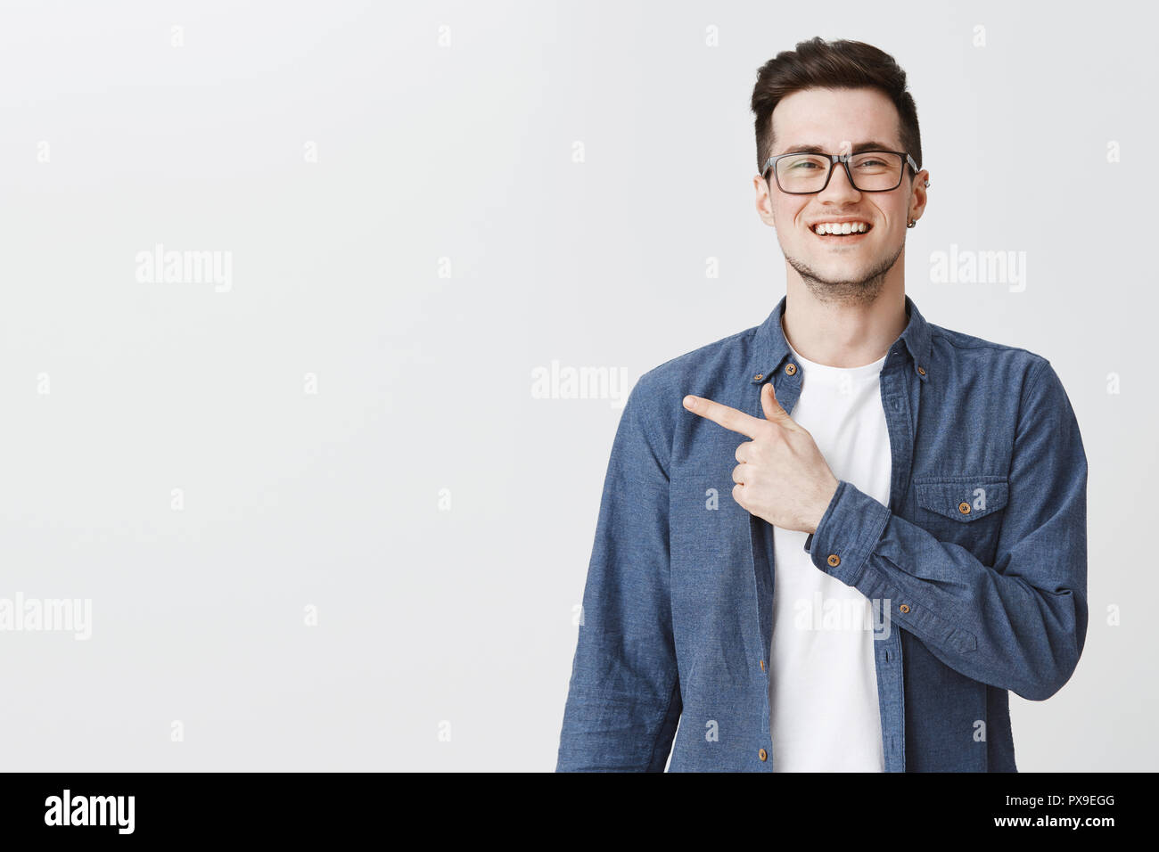 Polite and friendly handsome young caucasian man in glasses and blue ...