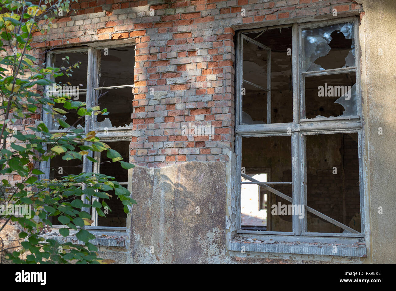 A broken window in an old abandoned building. Broken glass on the ...