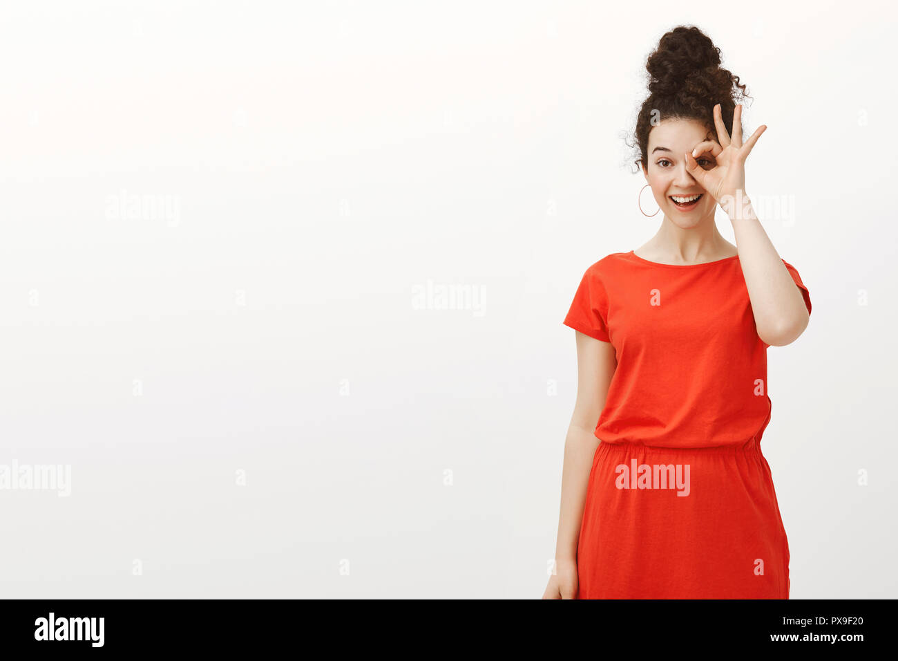 Indoor shot of playful good-looking feminine girl with curly hair in ...