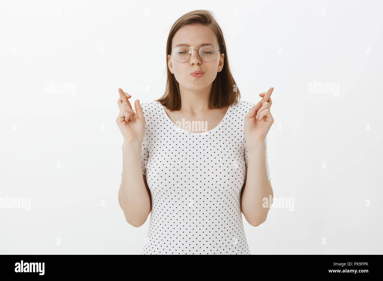 Hope god hear prayers. Studio shot of intense determined good-looking ...