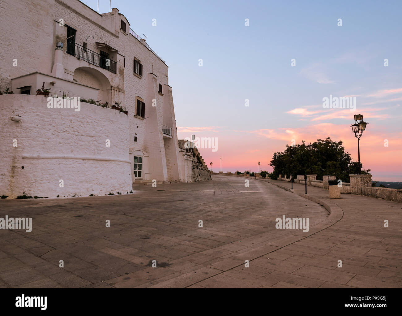 Walls of the medieval white village of Ostuni at sunset Stock Photo - Alamy