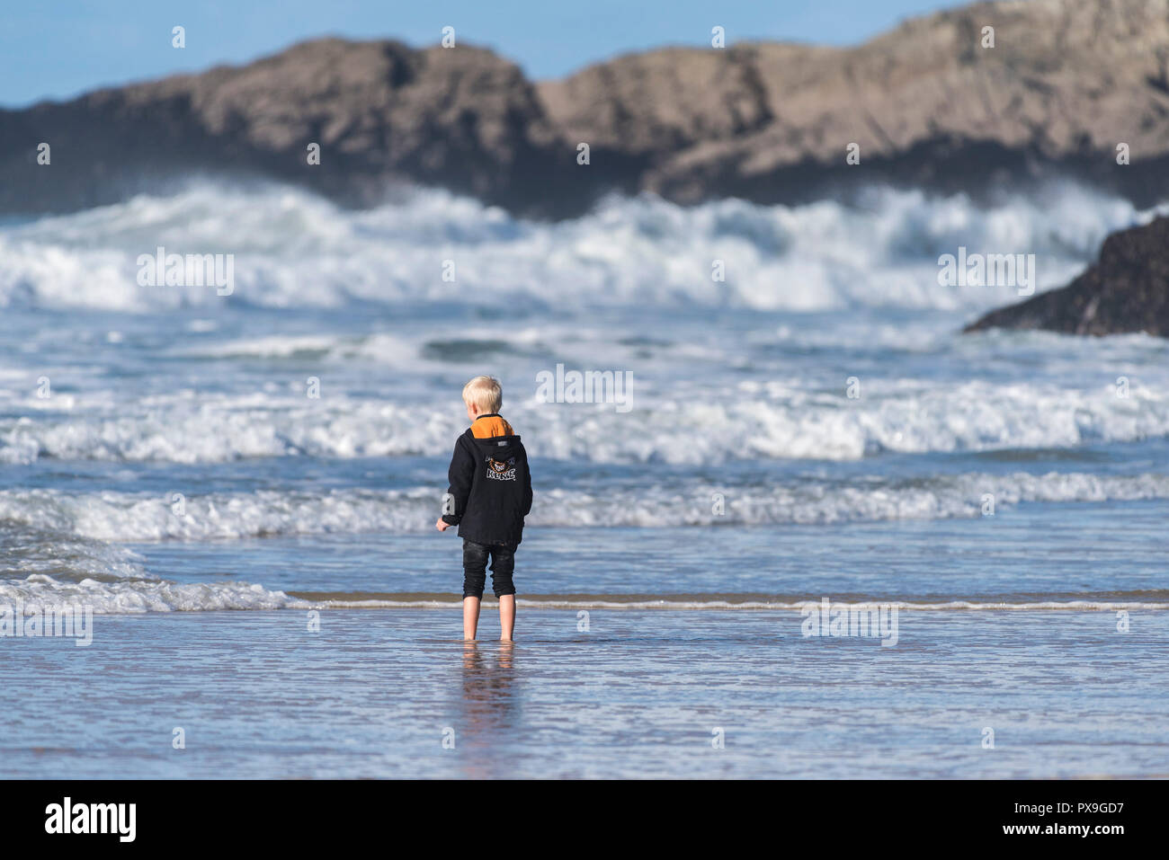 Boy standing sea watching waves hi-res stock photography and images - Alamy
