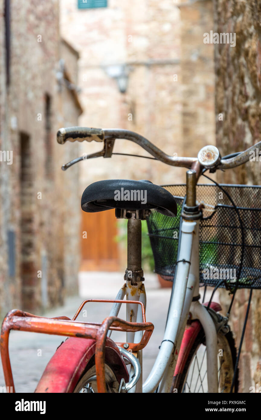 Red old bicycle with rust in a little alley of a medieval village Stock ...