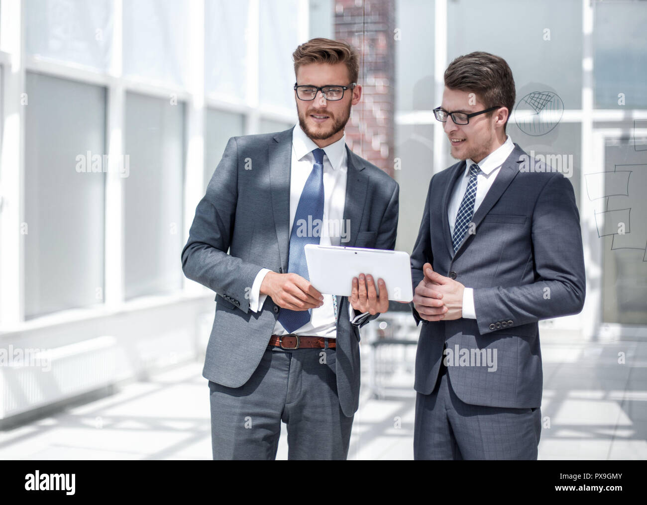 two employees standing in the office Stock Photo - Alamy