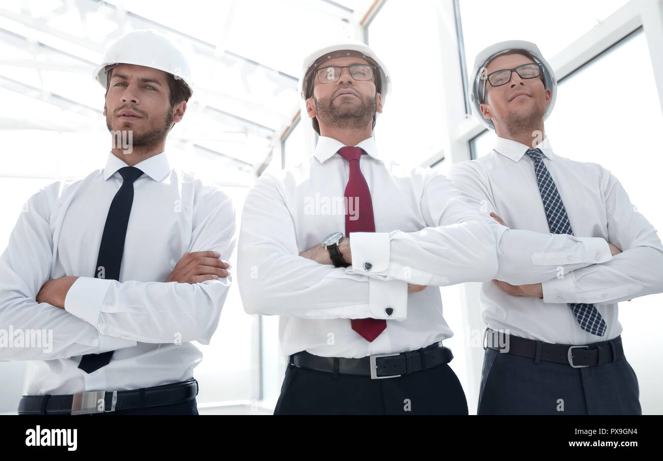 three architects standing in an empty office Stock Photo - Alamy