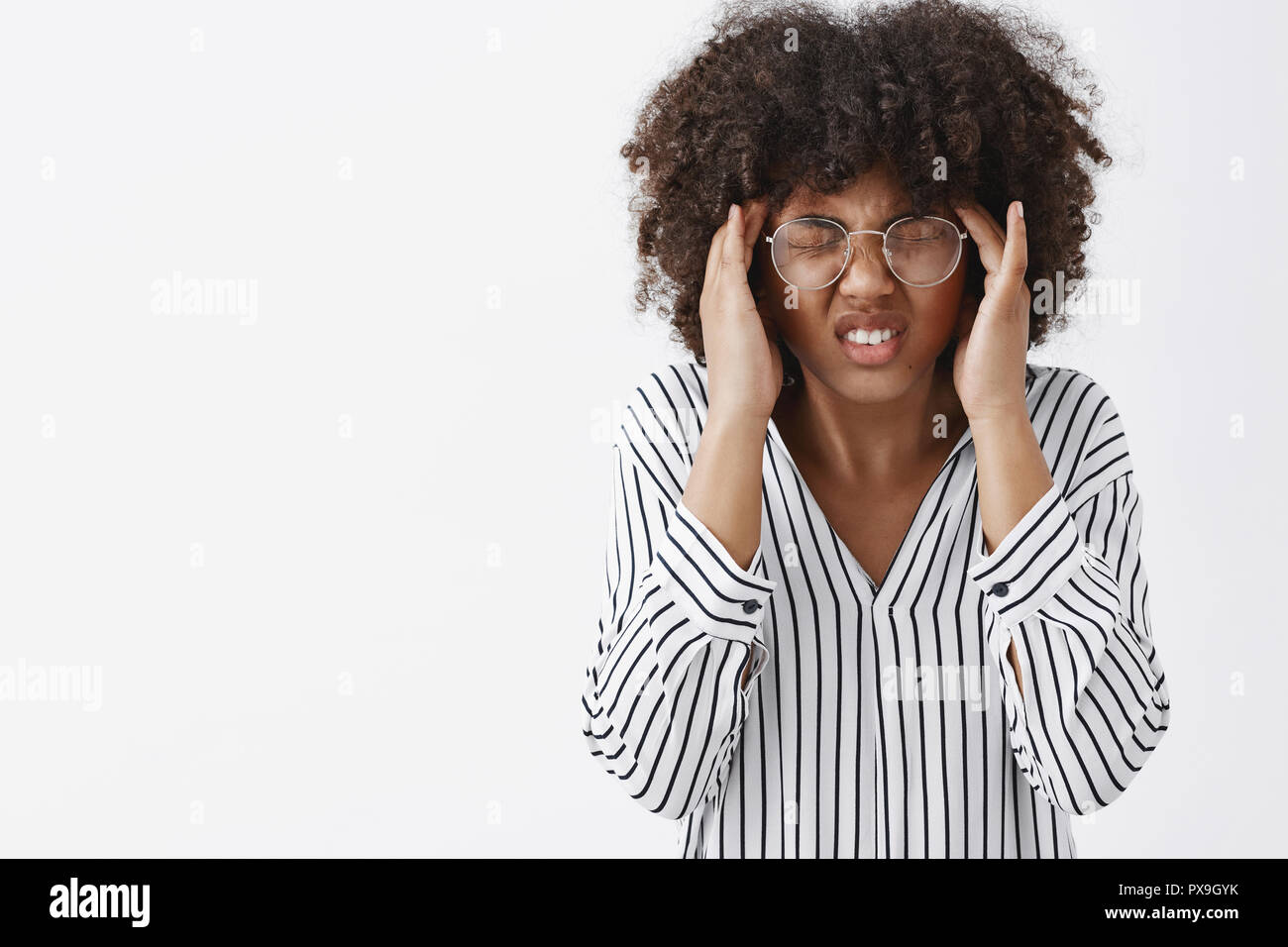 Concerned dark-skinned woman feeling discomfort cannot focus from ...