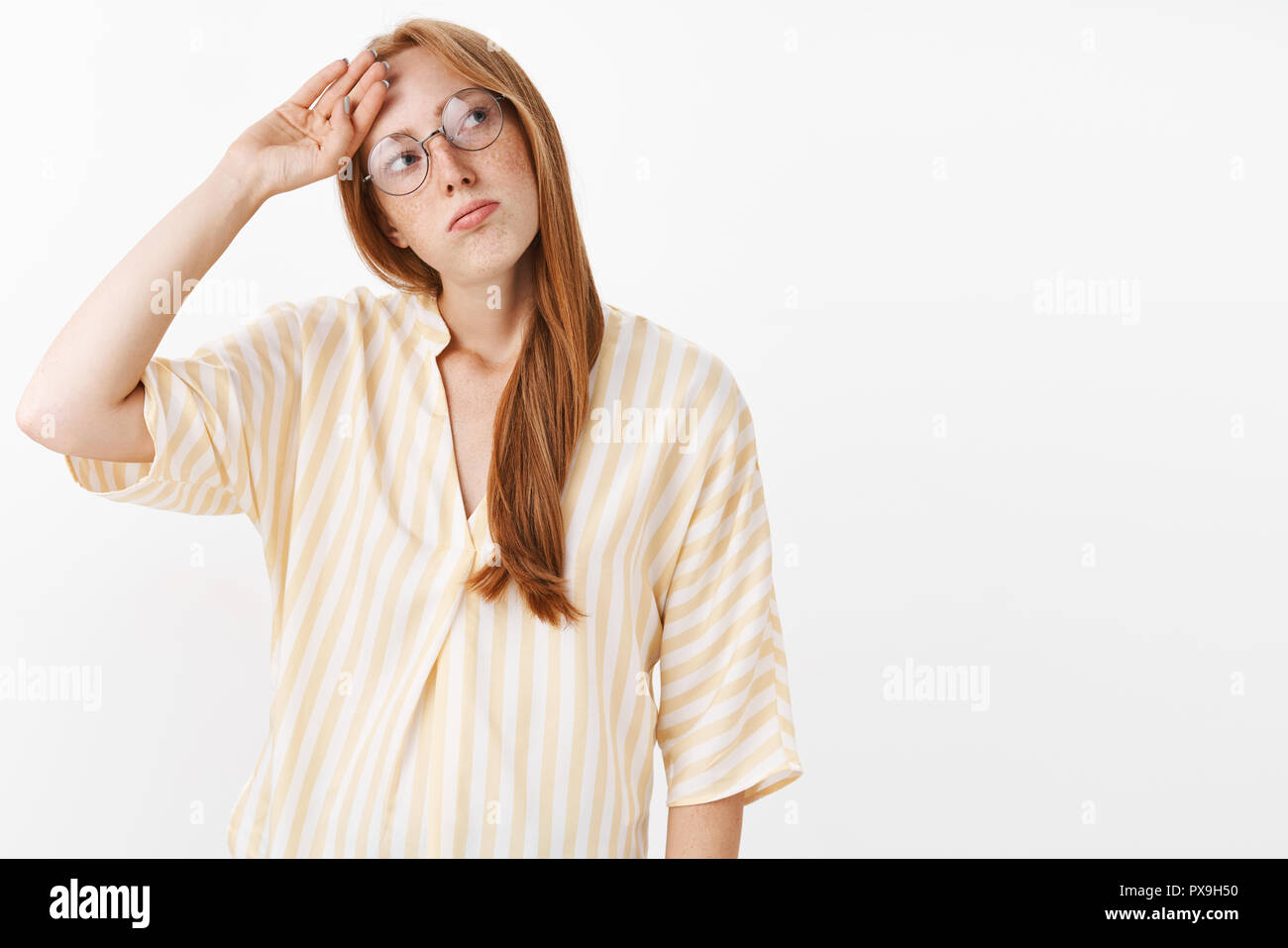 Phew work finally done. Portrait of tired unemotive gloomy redhead girl ...