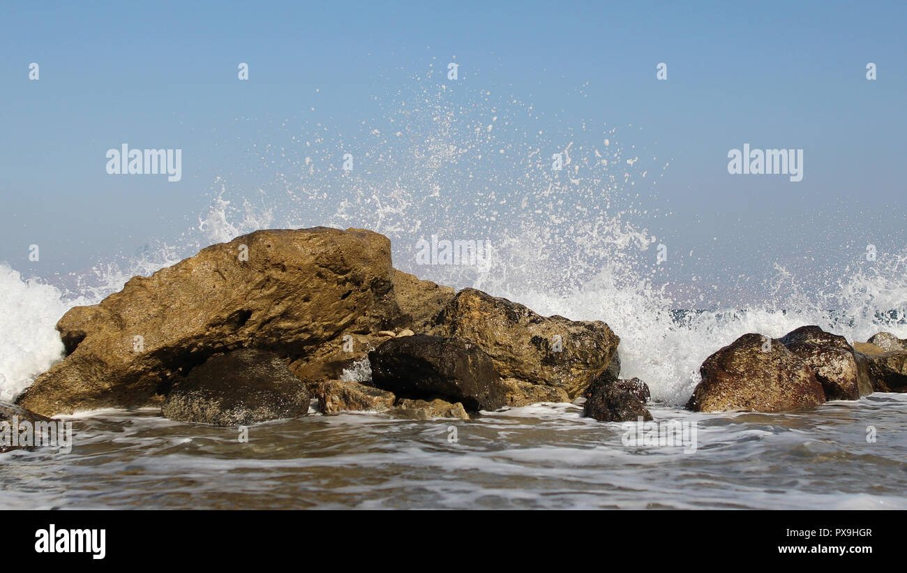 Powerful sea waves hitting rocks by the shore Stock Photo - Alamy