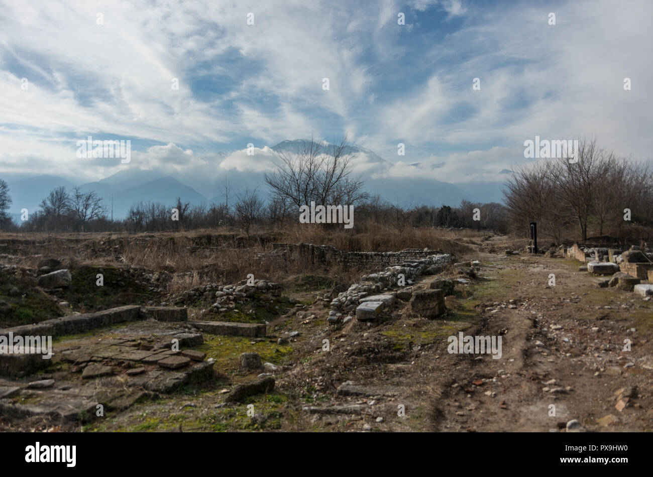 Ruins of building at Dion archaeological site with Olympus mountain at ...